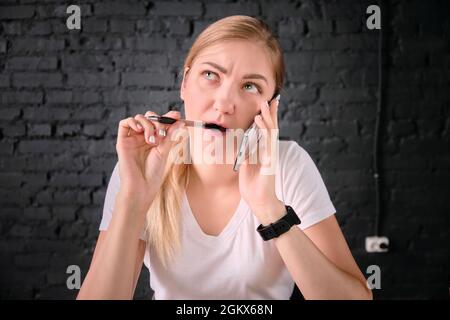 Serious-looking thoughtful smart perplexed woman solving riddle puzzle ...
