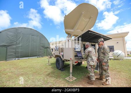 Soldiers from 40th Expeditionary Signal Battalion set up and test a Ka ...
