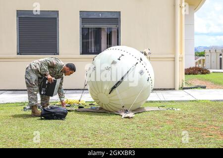 Soldiers from 40th Expeditionary Signal Battalion set up and test a Ka ...