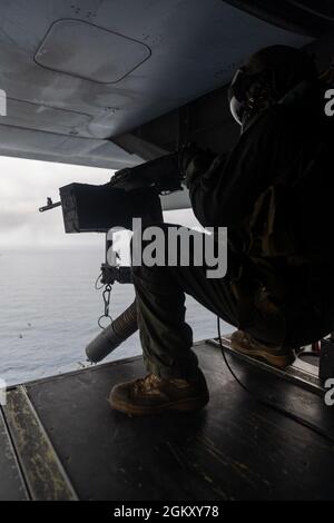 A U.S. Marine with the Advanced Machine-Gun Course, loads ammunition ...