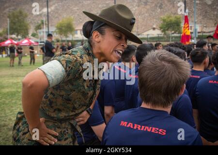 Marine Corps Drill Instructor Staff Sgt. Kayla Cerda motivates a poolee ...