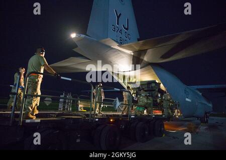 U.S. Marines and Airmen unload an AN/TPS-80 Ground/Air Task Oriented ...