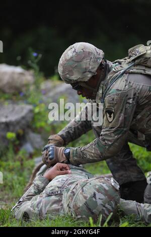 Sgt. 1st Class Jonathan Tyndall completes the hand release push-up ...