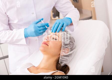 Woman getting facial contouring injections Stock Photo - Alamy