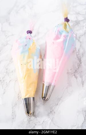 Colorful meringue in piping bags with metal piping tips Stock Photo - Alamy