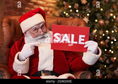 Portrait of bearded santa claus pointing with finger isolated on red ...
