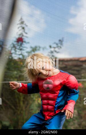 Child with static hair on trampoline in backlight Stock Photo - Alamy