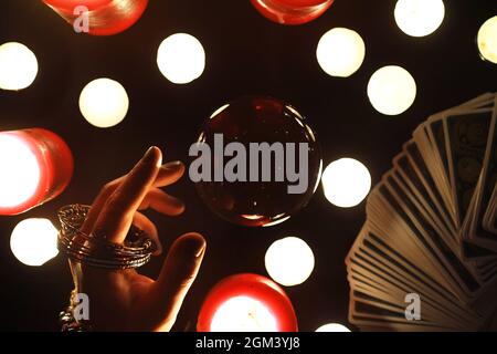 Mystic still life with voodoo doll, the tarot cards, books, evil candles and witchcraft objects ...