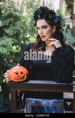 Jack-O-Lantern pumpkin on black veil near violet wall Stock Photo - Alamy