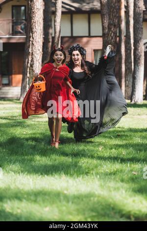 mom and daughter in red dresses communication emotions lifestyle yellow ...