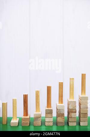 Stick wood block standing on stacked square wood blocks, abstract ...