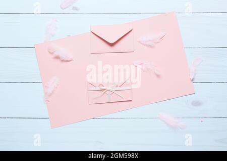 Blank card with envelopes and feathers on blue wooden background Stock ...