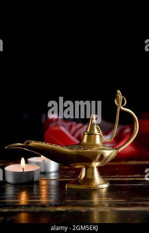 Lamp, candles and flag of Afghanistan on table against dark background ...