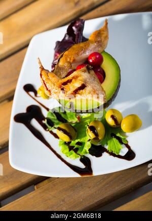 Delicious fried legs of quail with balsamic pasta, avocado and greens ...