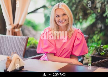 Photo of sweet attractive lady pensioner dressed blue pullover holding ...