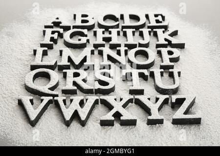 Alphabet letters on scattered flour Stock Photo - Alamy