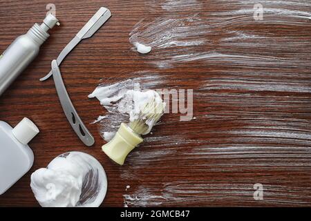 Shaving accessories on a wooden texture background. Tools. Disposable ...