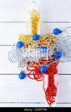 Glasses with champagne and golden Christmas balls Stock Photo - Alamy