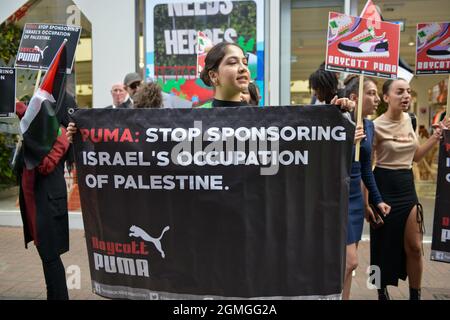 A protester standing behind a banner during the demonstration.Boycott ...