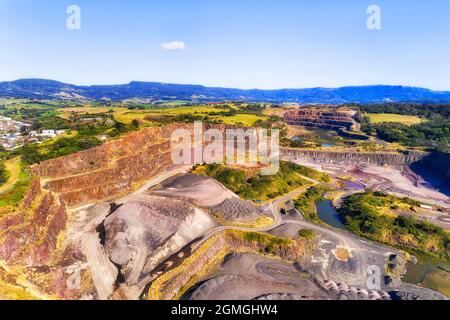 Aerial view basalt quarry of open pit mine machines with sifters and ...