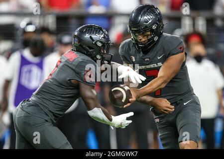 UNLV quarterback Cameron Friel (7) hands off the ball to running back ...