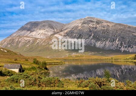 ARKLE MOUNTAIN SUTHERLAND SCOTLAND REFLECTED IN LOCH STACK WITH ROWAN ...