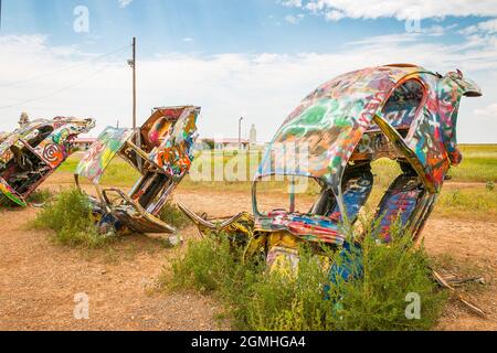 painted Volkswagen Beetles half buried at an angle at Slug Bug Ranch ...