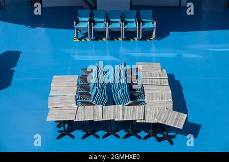 stacked chairs and tables on a ship of the cruise company Koeln ...