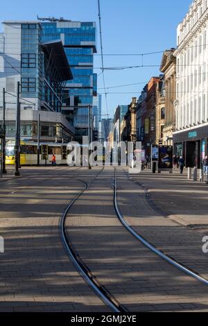 UK, England, Manchester, Cable cars moving along downtown street at ...
