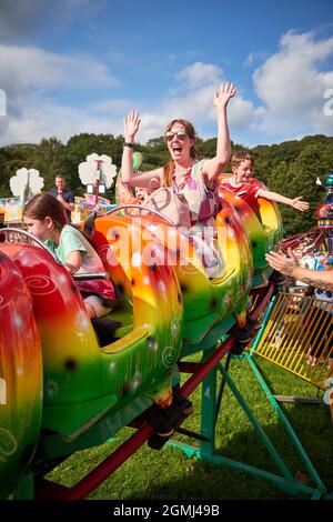 Riding a colourful dragon children's fair ground ride Stock Photo - Alamy