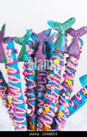 Mermaid chocolate pretzel rods drizzled with pink and purple chocolate ...