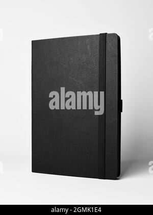 Black vertical notebook with elastic band on white background Stock ...