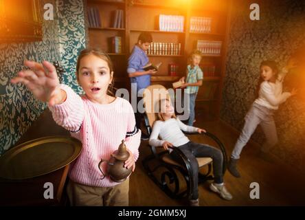 Tween girl trying to reach out something in escape room,toned image ...