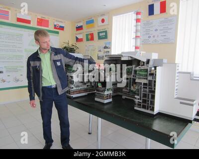 An employee of the Chernobyl Nuclear Power Plant working in the control ...