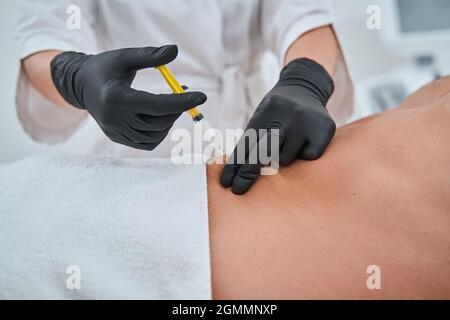 Dermatologist performing non invasive fat reduction procedure in beauty ...