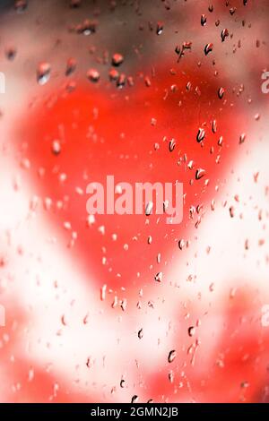 Blurry red heart shape window with raindrops. Valentine's Day, unhappy love Stock Photo - Alamy