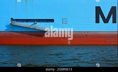 Blue hull with gangway of the container vessel from the shipping ...