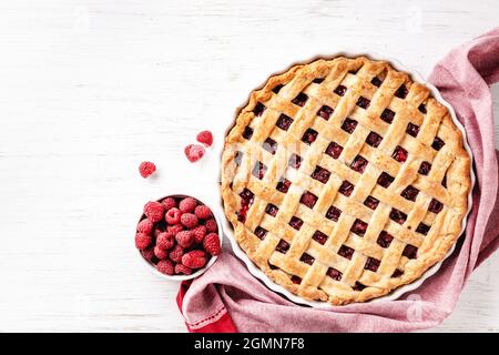 Classic American raspberry pie in ceramic baking pan on white ...