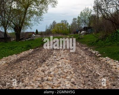 a road of stone rubble through the village, in spring Stock Photo - Alamy