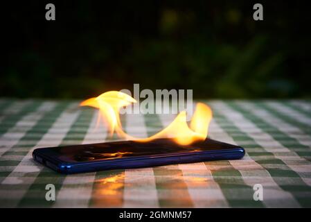 Mobile phone explodes and burns. Cell Phone explosion and fire. Smart ...