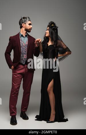 interracial couple in vampires halloween costumes growling and showing ...