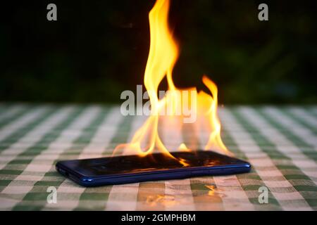 Mobile phone explodes and burns. Cell Phone explosion and fire. Smart ...