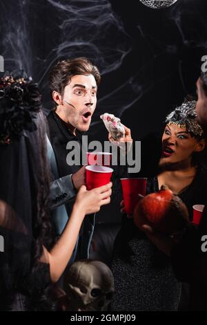 friends in halloween costumes scaring Stock Photo - Alamy