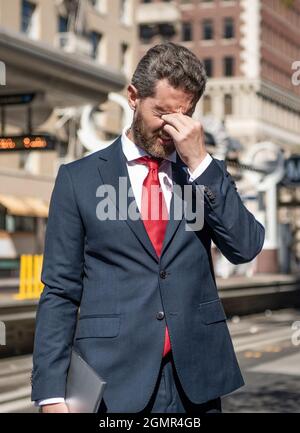 stressed freelance man hold pc outdoor, employer Stock Photo - Alamy