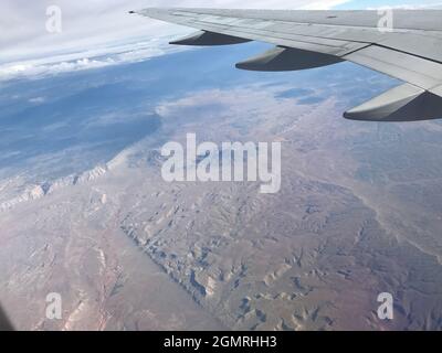 Window view of airplane wing of western United States ripple texture ...