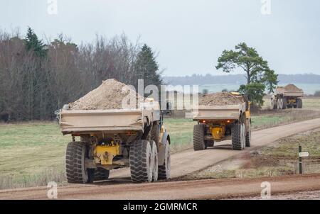 three yellow Volvo A40E articulated dump truck earth mover with 25 ...