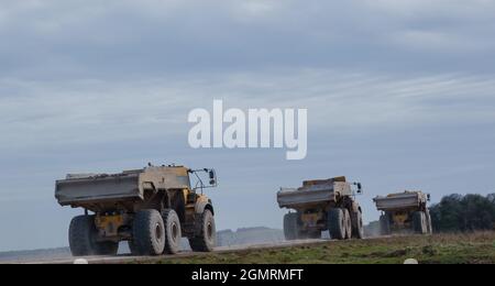 three yellow Volvo A40E articulated dump truck earth mover with 25 ...
