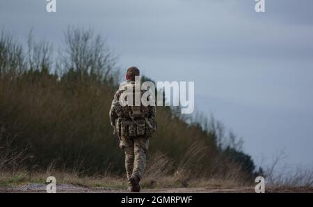 British army soldier completing an 8 mile combat training test tabbing ...