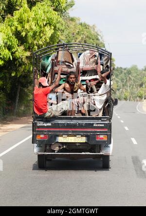 Men Riding In The Back Of A Van Stock Photo - Alamy