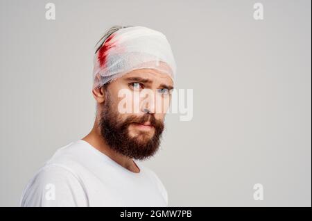 patient bandaged head and hand blood light background Stock Photo - Alamy